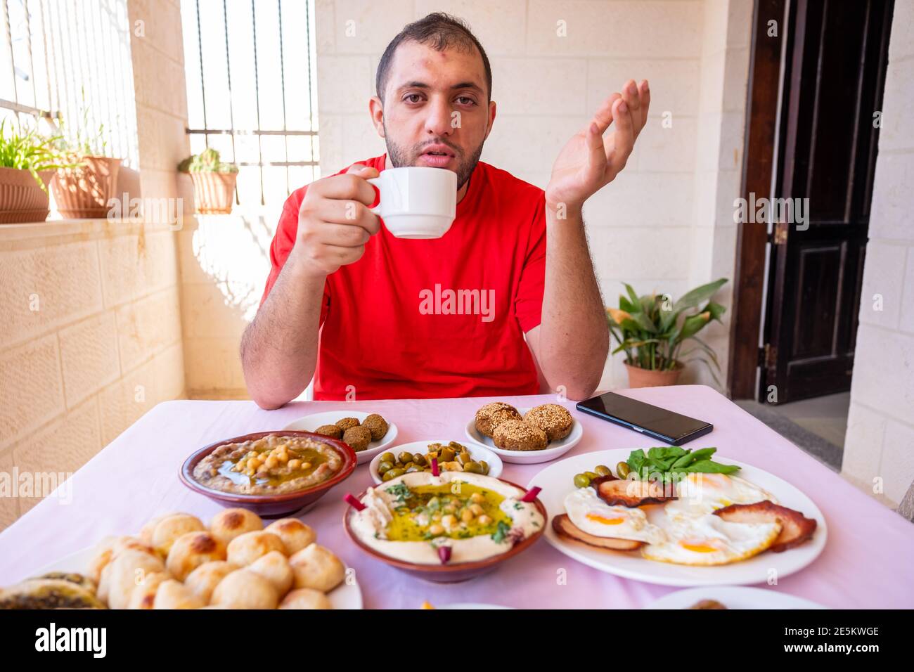 Happy muslim man is drinking his tea Stock Photo - Alamy