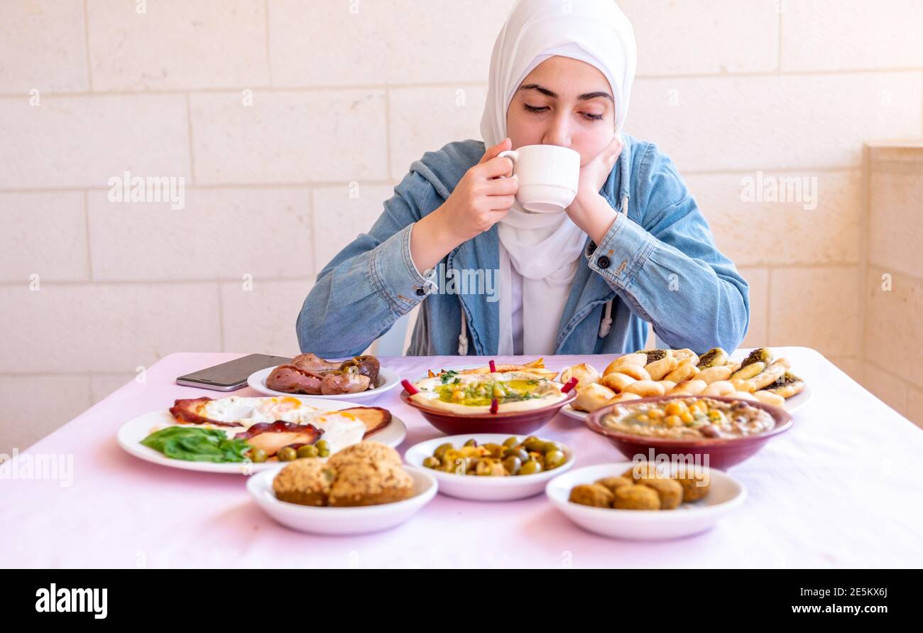 Muslim girl is drinking tea Stock Photo - Alamy