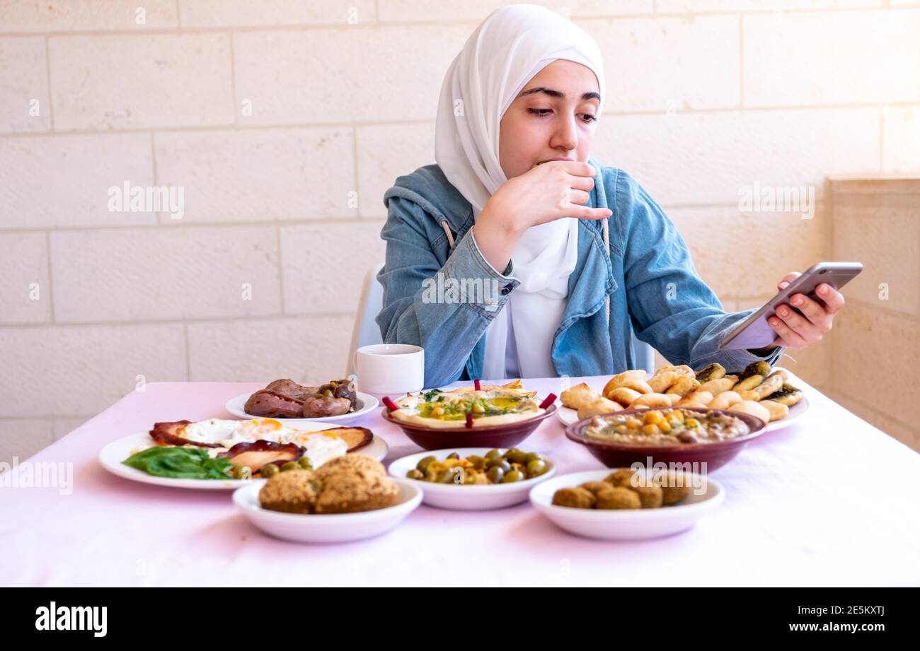 muslim girl is eating her breakfast Stock Photo - Alamy