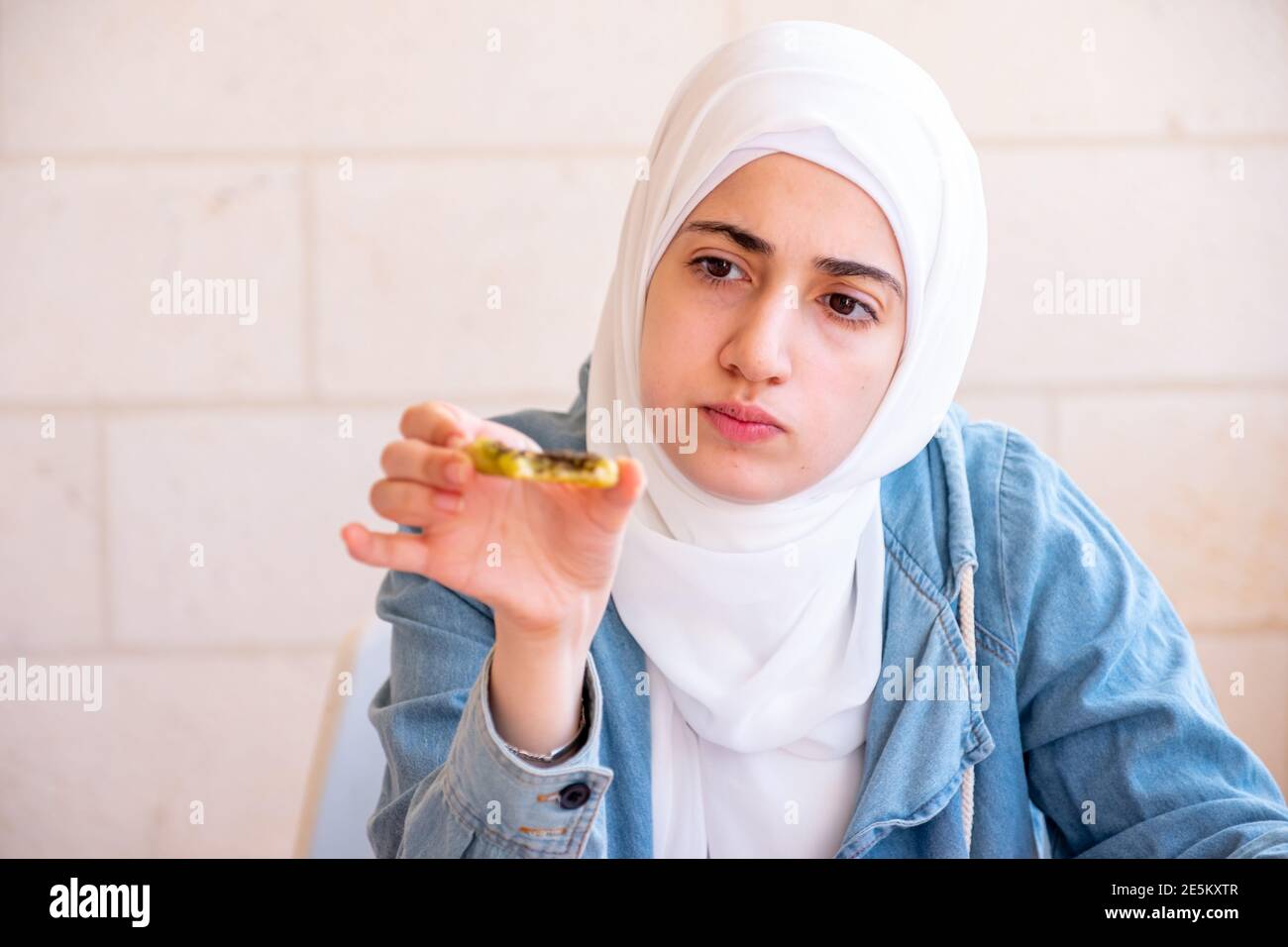 Muslim girl is eating her breakfast Stock Photo - Alamy