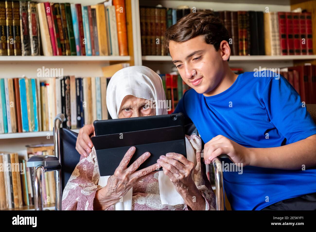 Old woman is holding her tablet Stock Photo - Alamy