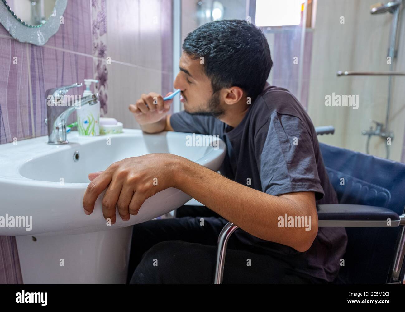 Muslim young man with special needs is trying to depend on himself ...