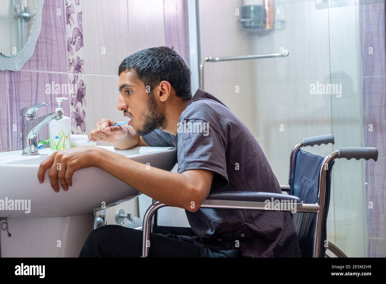 Muslim young man with special needs is trying to depend on himself ...