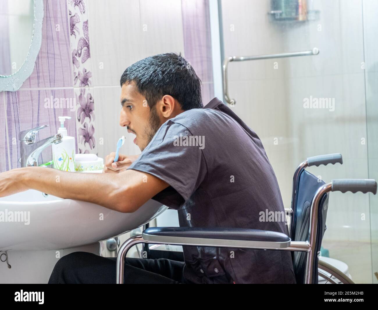 Muslim young man with special needs is trying to depend on himself ...