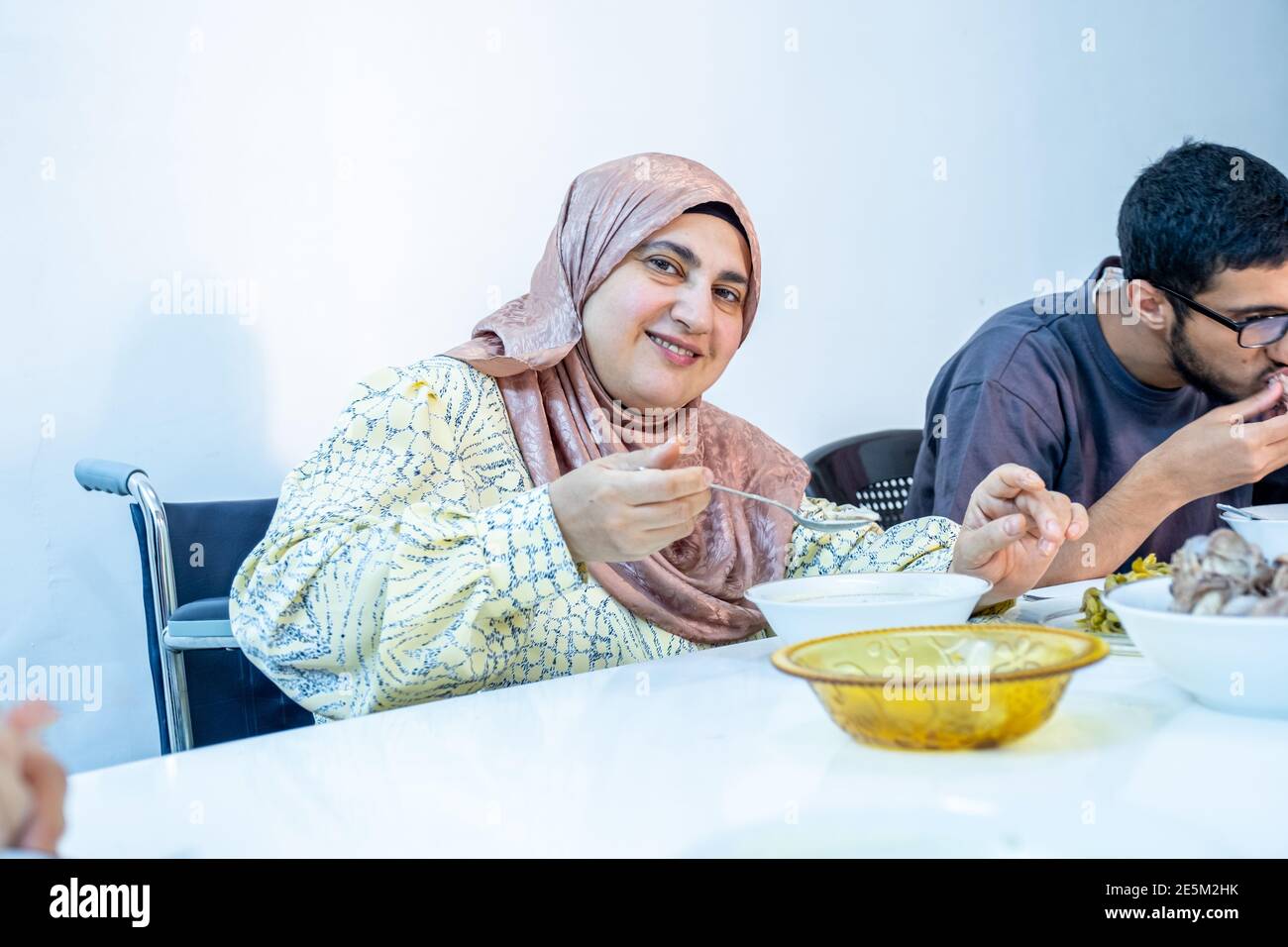 Muslim family eating their meal together Stock Photo - Alamy
