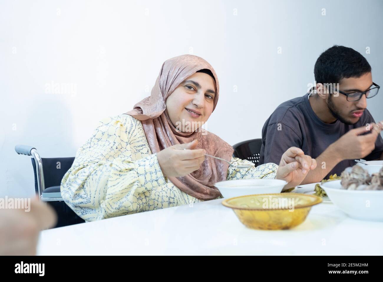 Muslim family eating their meal together Stock Photo - Alamy