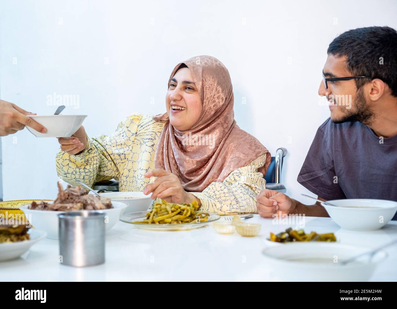 Muslim family eating their meal together Stock Photo - Alamy
