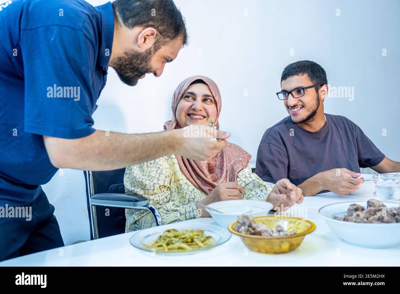Muslim family eating their meal together Stock Photo - Alamy