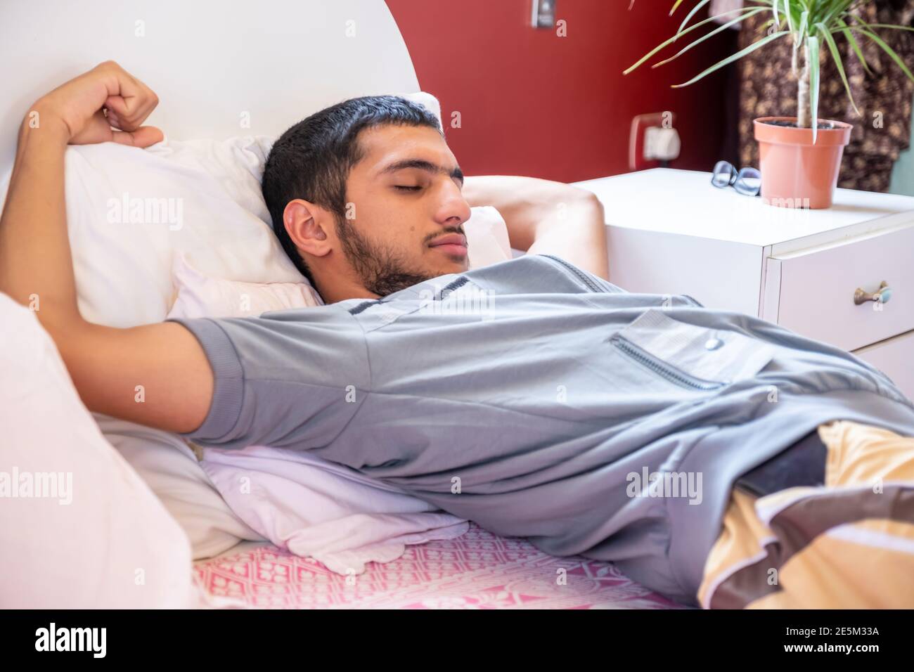 Muslim man having a nap in the bed room Stock Photo - Alamy