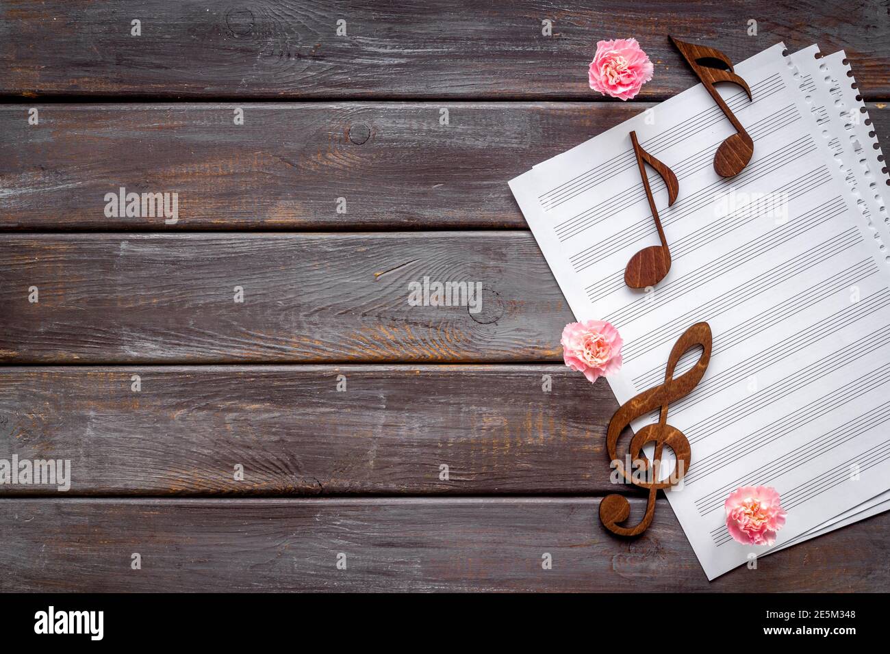Musical wooden notes on music sheet. Top view Stock Photo - Alamy