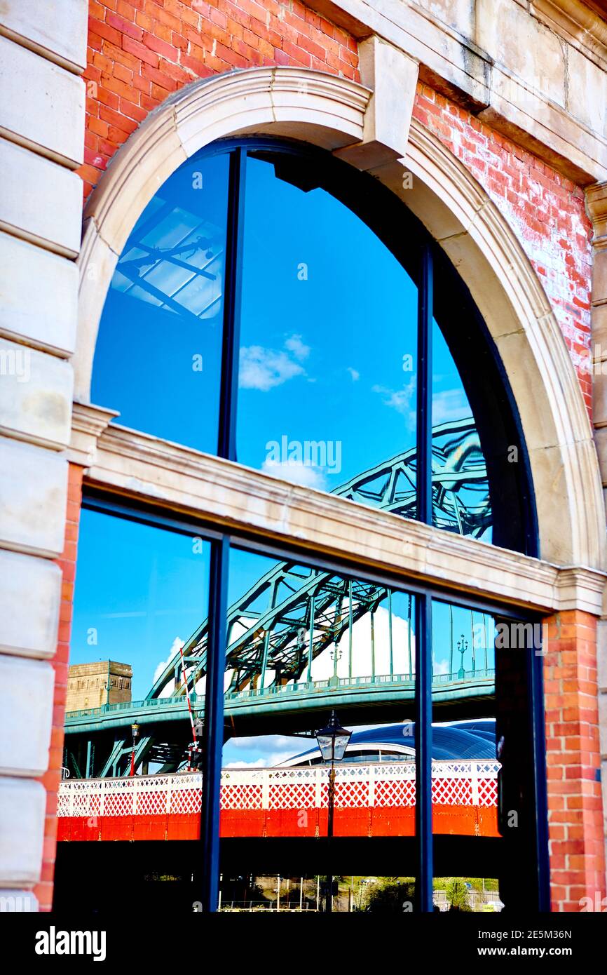 Reflection of the Tyne Bridge in a window in the Summer on the Quayside ...