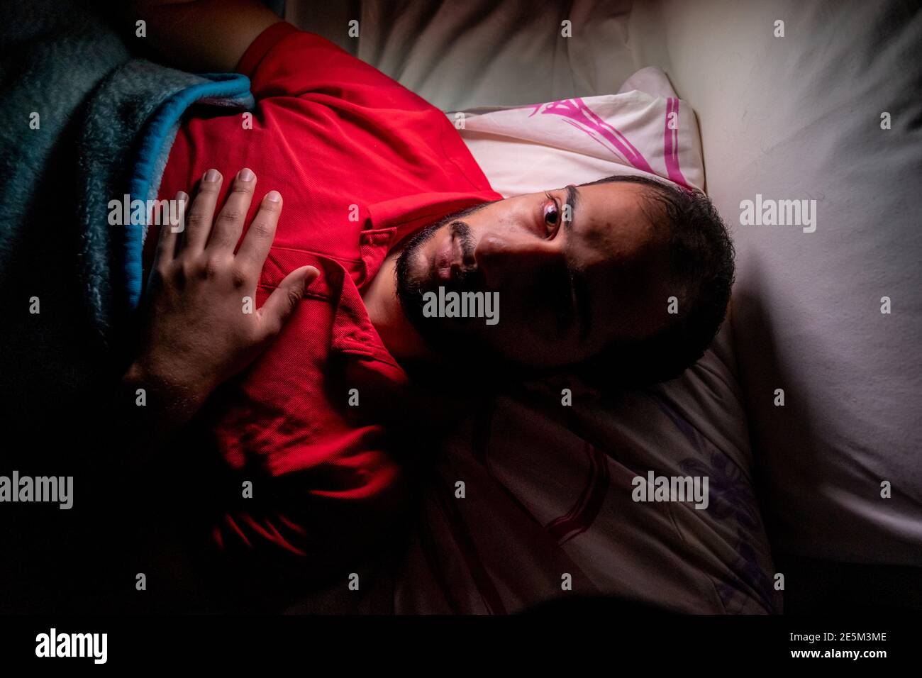 Muslim man sleeping in a dark room with small light Stock Photo - Alamy