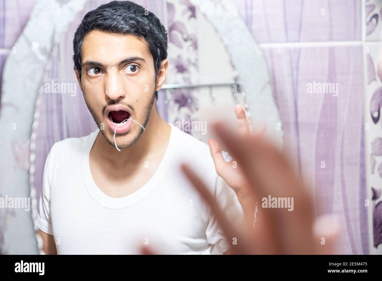 Muslim man is using a dental thread Stock Photo - Alamy