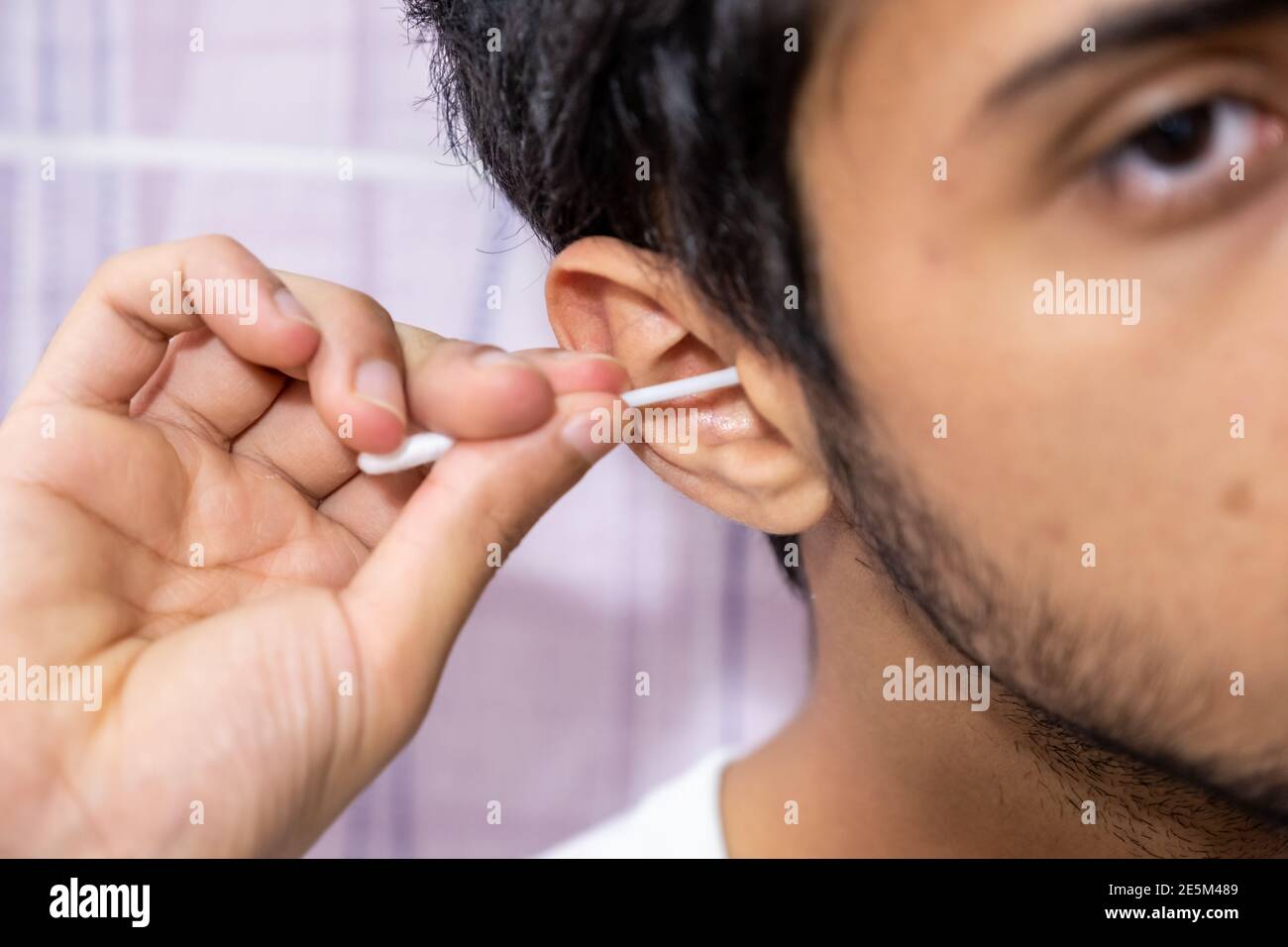 Muslim man cleaning his ear Stock Photo - Alamy