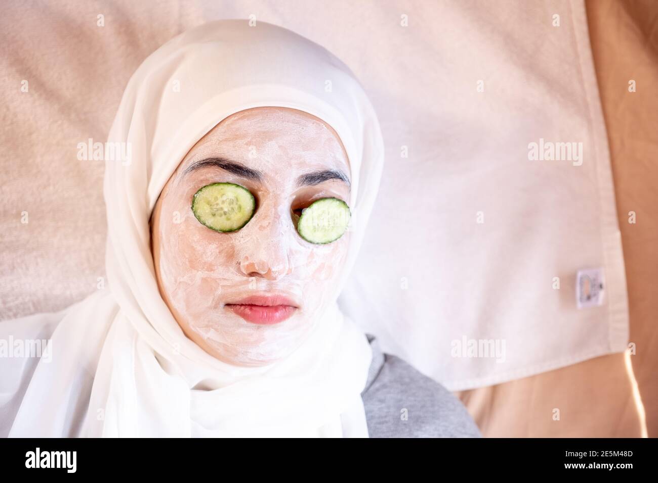 Muslim woman laying down in a spa with facial mask Stock Photo - Alamy