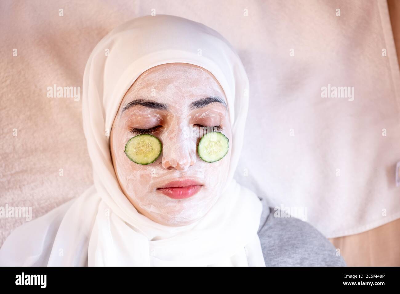 Muslim woman laying down in a spa with facial mask Stock Photo - Alamy
