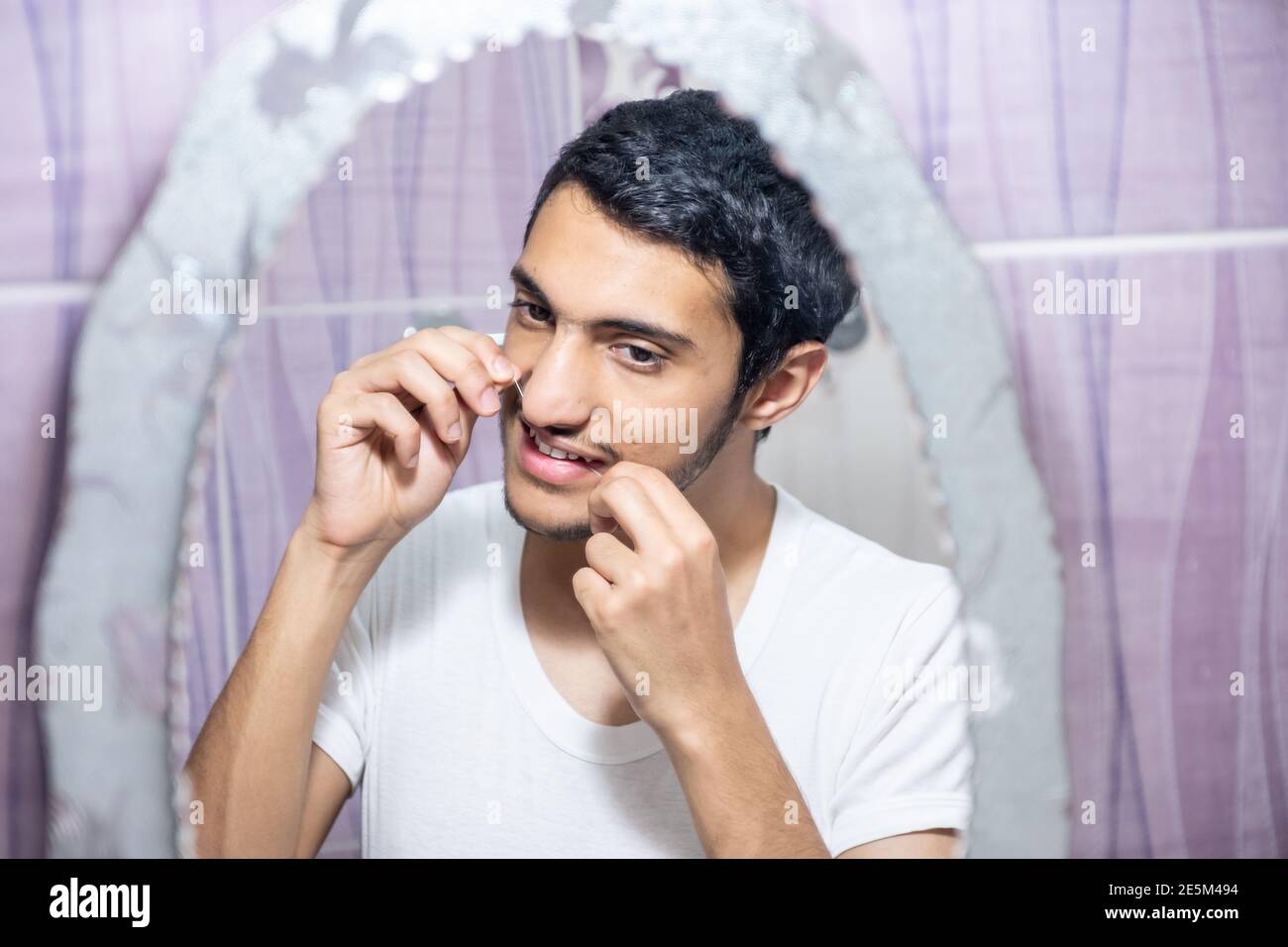 Muslim man is using a dental thread Stock Photo - Alamy