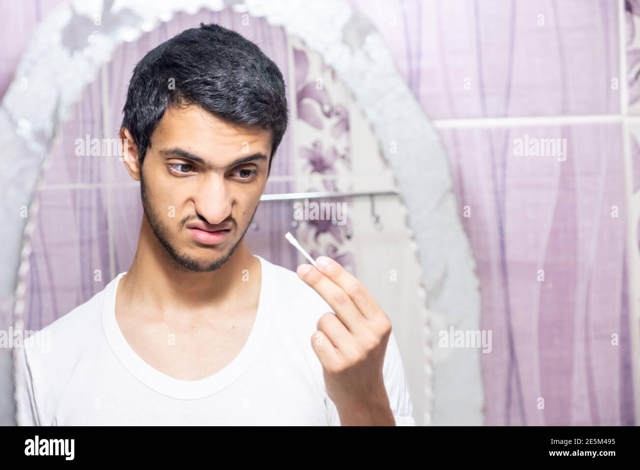 Muslim man cleaning his ear Stock Photo - Alamy