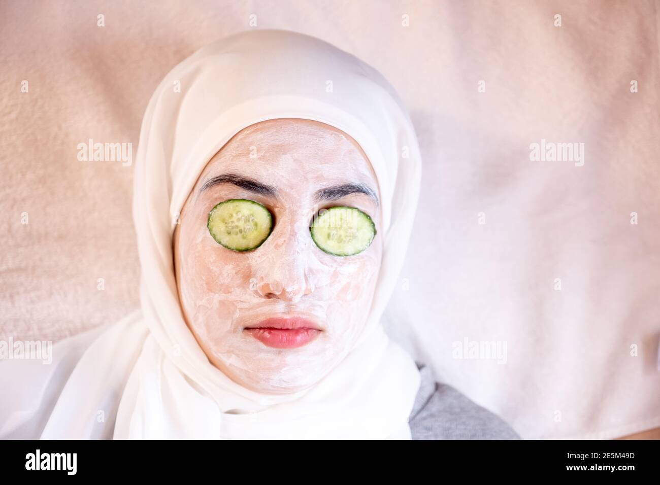 Muslim woman laying down in a spa with facial mask Stock Photo - Alamy