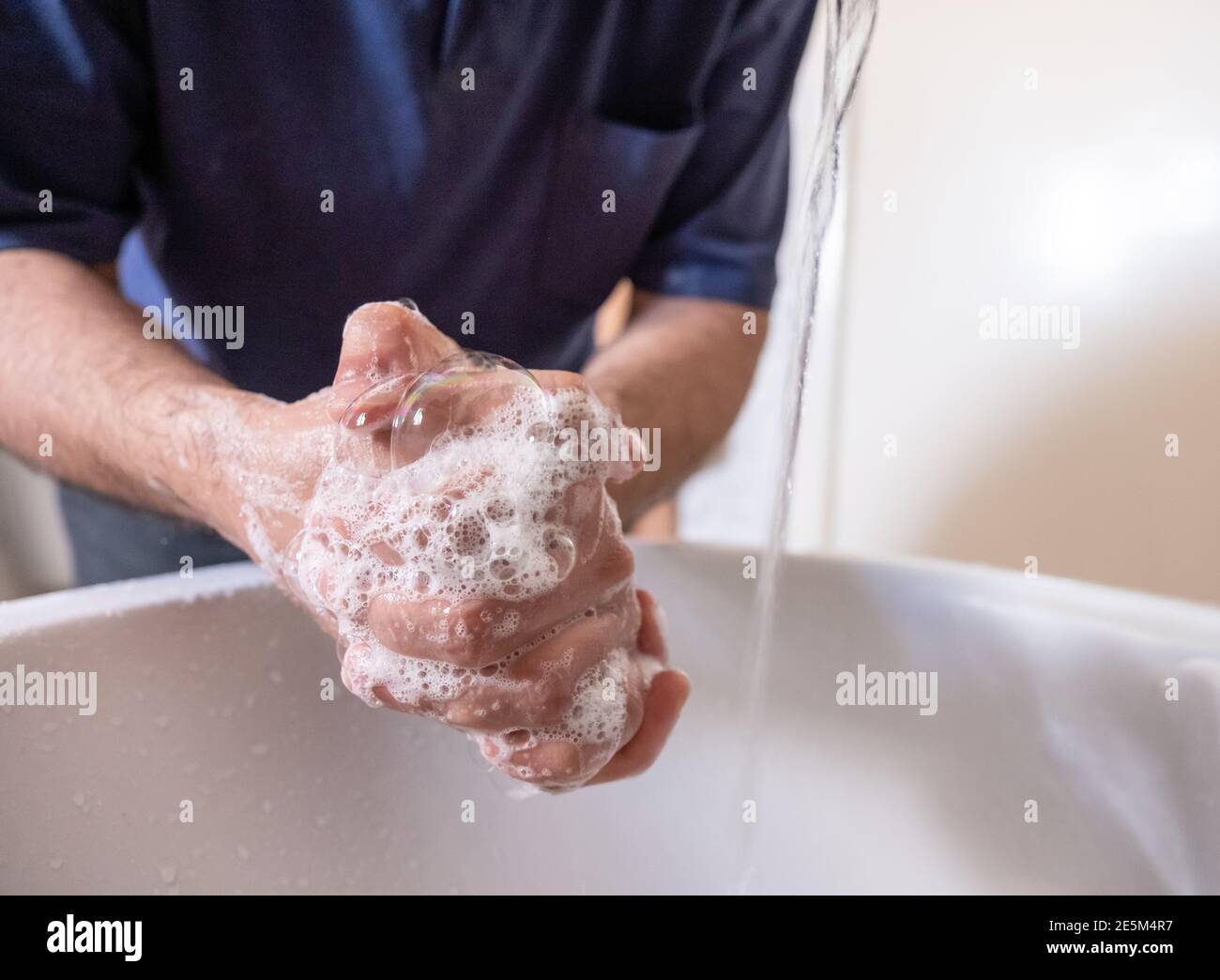 Muslim guy washing his hands Stock Photo - Alamy