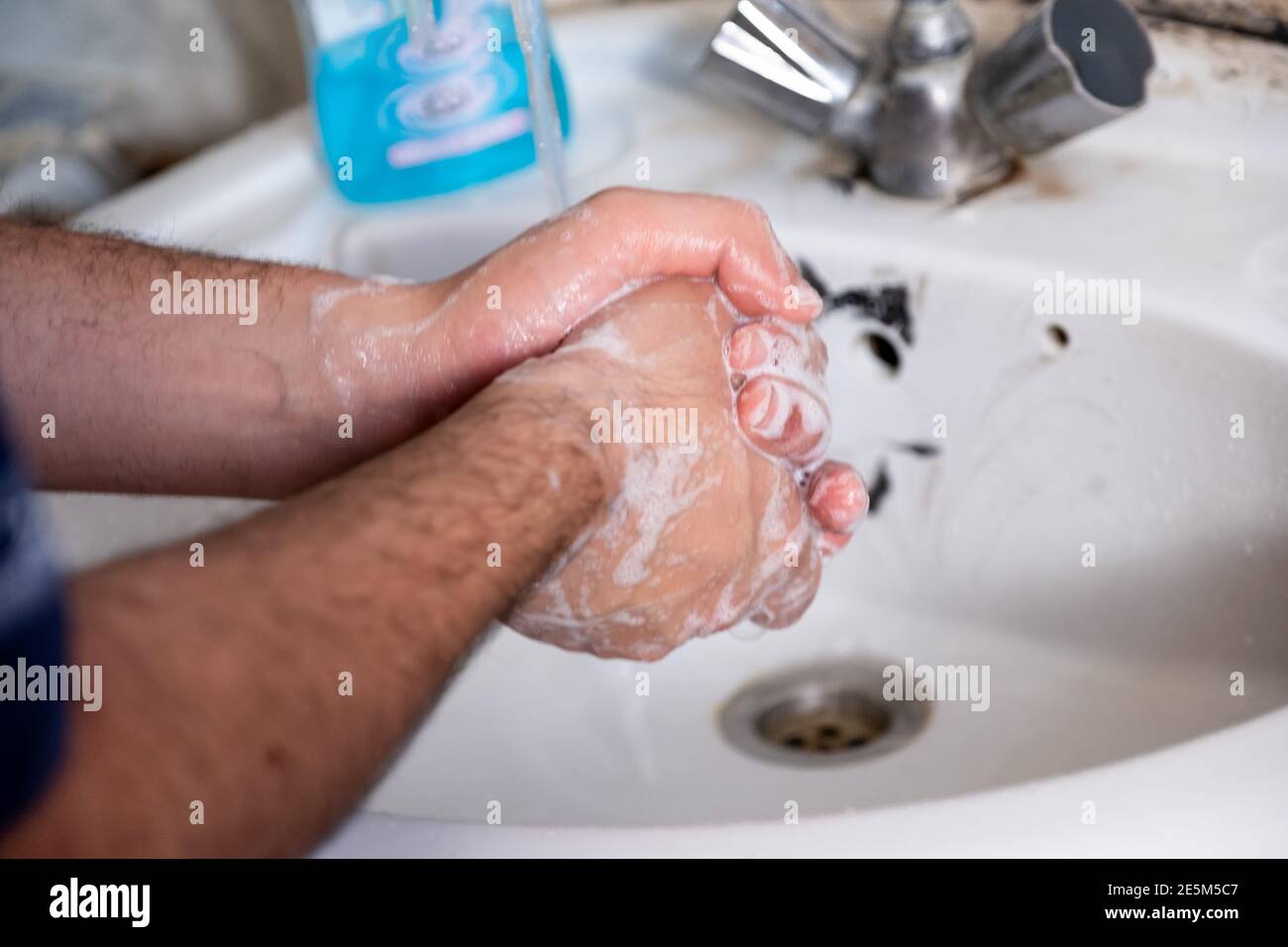 Muslim guy washing his hands Stock Photo - Alamy