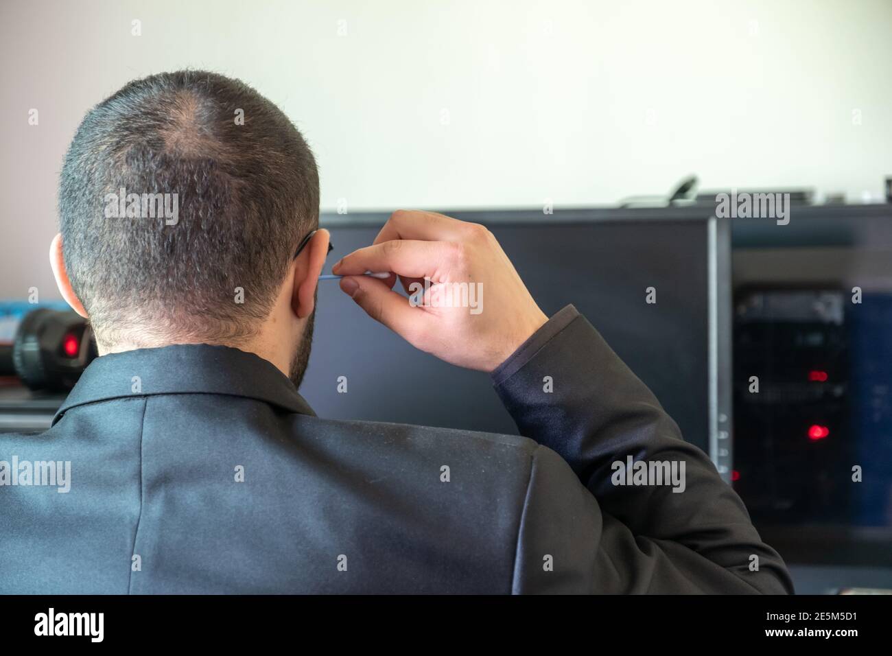 Arabic guy cleaning his ear from earwax Stock Photo - Alamy