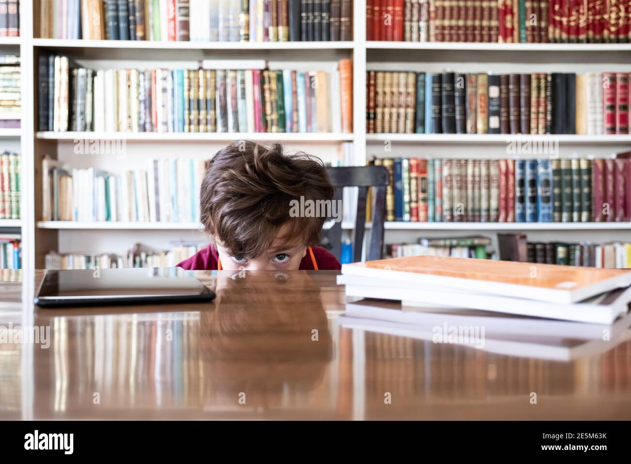 little boy in the library Stock Photo - Alamy