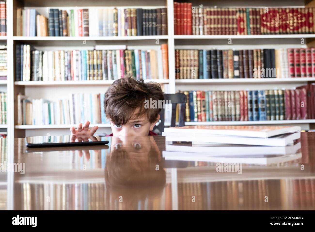 little boy in the library Stock Photo - Alamy