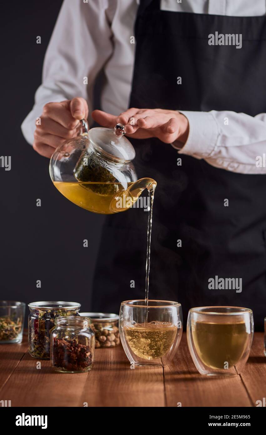 Tea master pouring green tea into glass cups from a pot Stock Photo - Alamy