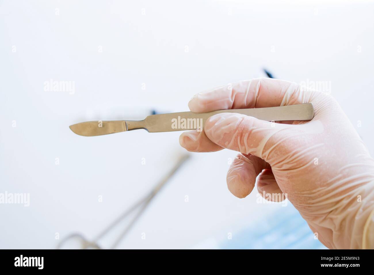 Surgery knife holding on the white background, studio shot. Operation ...