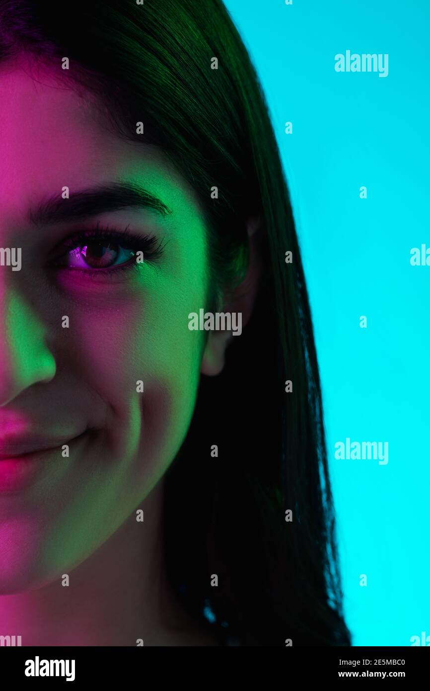 Half-full. Close up brunette woman's portrait isolated on blue studio ...