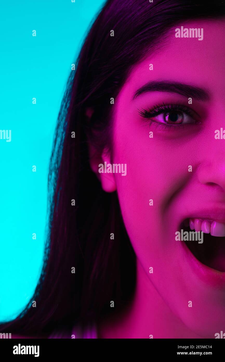 Half-full. Close up brunette woman's portrait isolated on blue studio ...