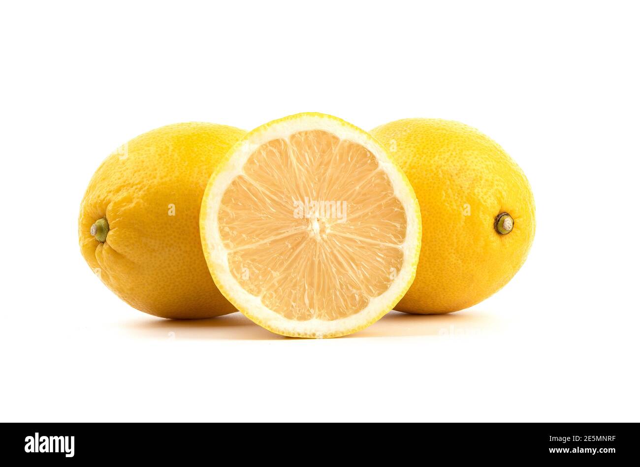 Half a lemon and two whole fruits on a white background. Clos up. Copy ...