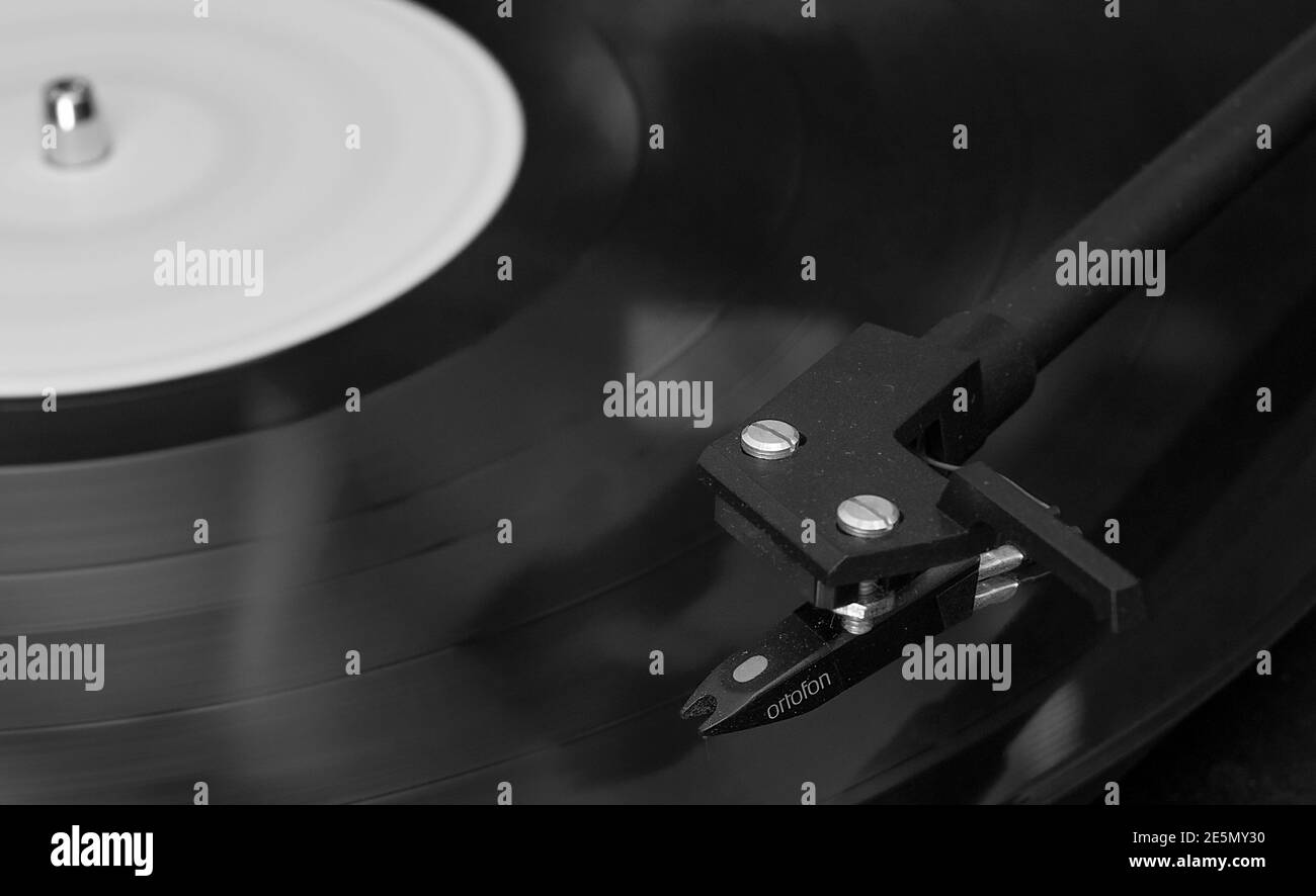 Vinyl Record on deck spinning with stylus in mono Stock Photo - Alamy