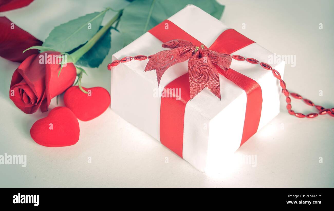 close up.gift box and red rose on a white background.concept of love ...