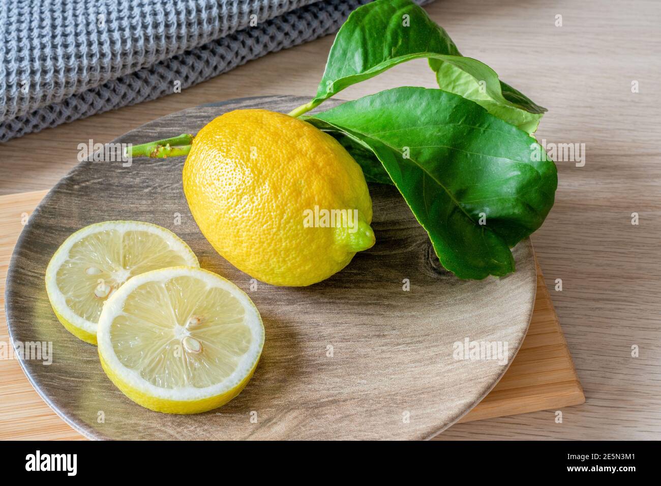 Lemon with lemon leaves and slices Stock Photo - Alamy