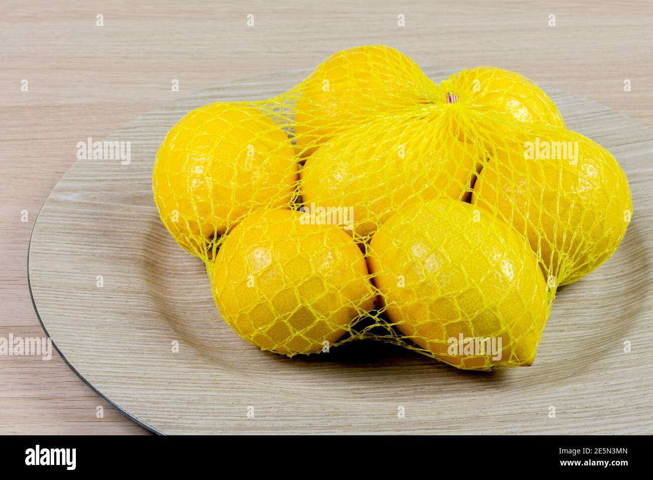 Lemons in a net Stock Photo - Alamy