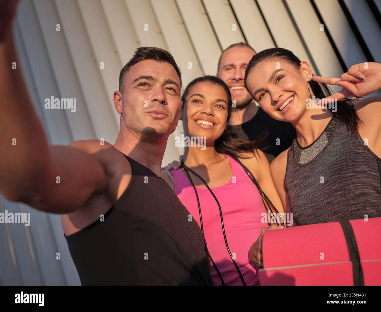 Happy young mixed race athletes taking selfie outdoors Stock Photo - Alamy