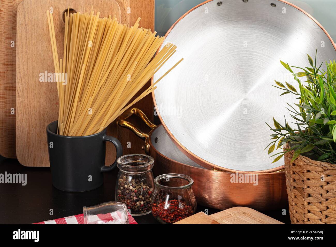 Dry spaghetti on a kitchen counter with cooking utensils Stock Photo ...