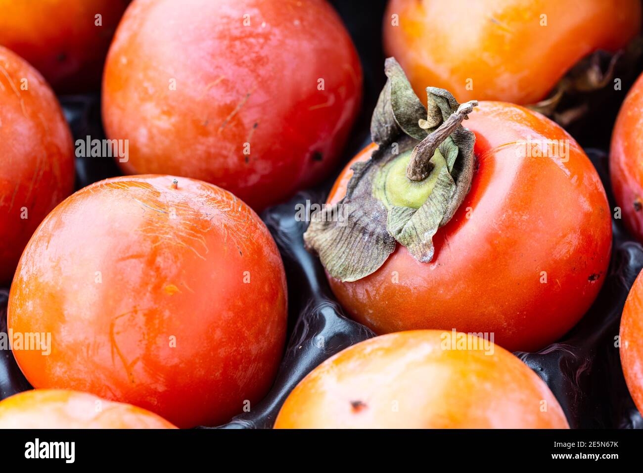 A market display of persimmons Stock Photo - Alamy