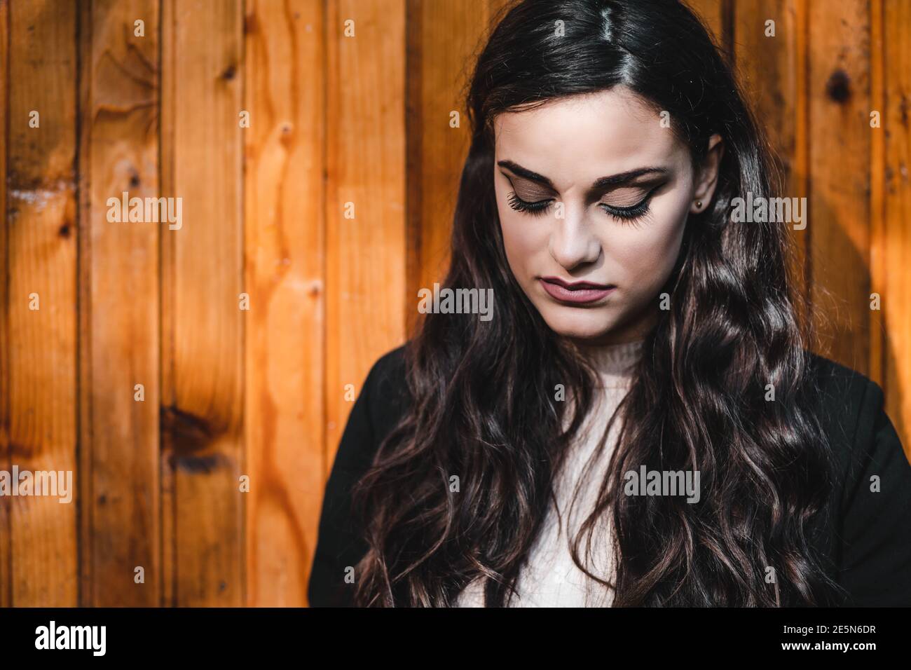 Portrait Of A Brunette Girl Looking Down Sad About Something Stock