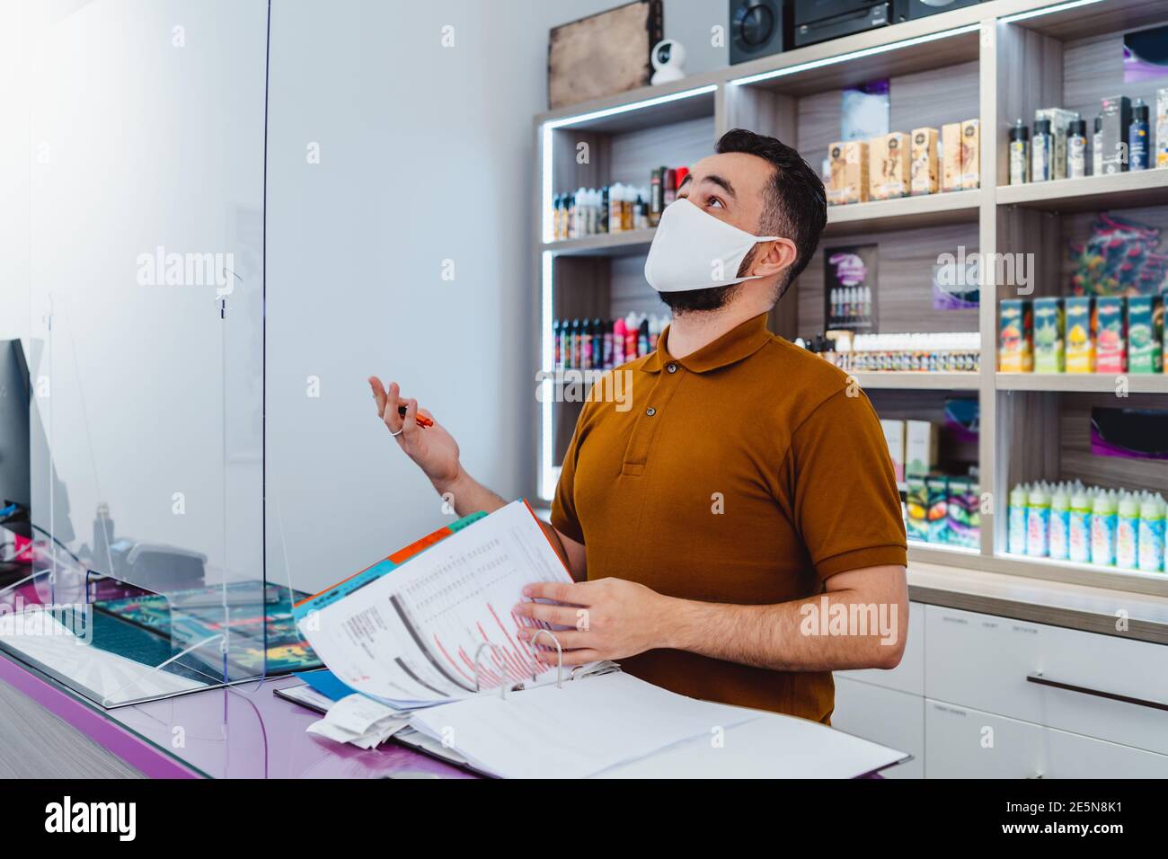 Sad young shop owner struggling with money during virus epidemic Stock ...