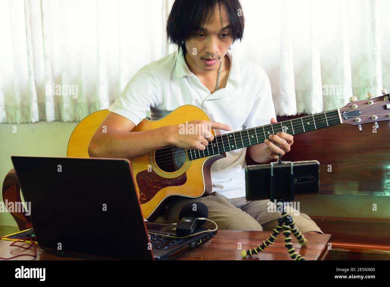 musician live streaming playing guitar show from home Stock Photo - Alamy