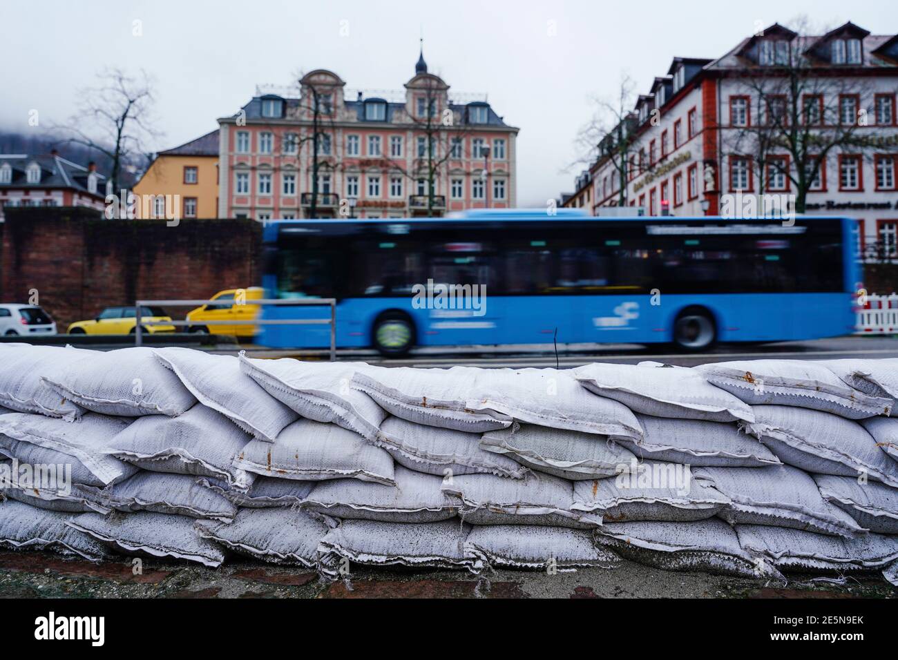 Heidelberg, Germany. 28th Jan, 2021. A bus drives past sandbags lying ...
