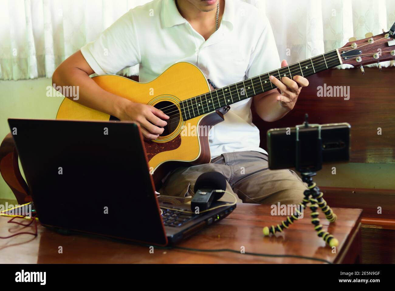 musician live streaming playing guitar show from home Stock Photo - Alamy