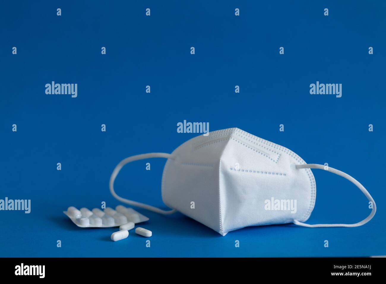 FFP3 mask, nasal drops, thermometer, tablets, various medicines lie on ...