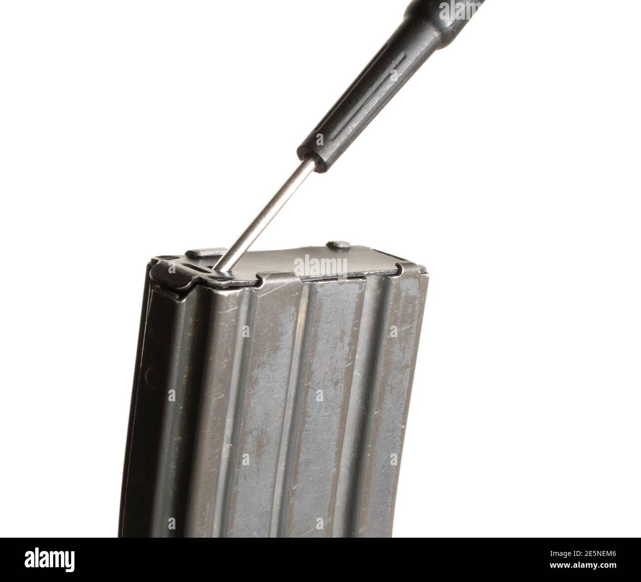 Tool prying up the bottom of an assault rifle magazine isolated on ...