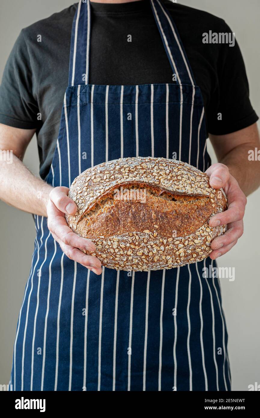 Holding a loaf of bread in his hands hi-res stock photography and ...