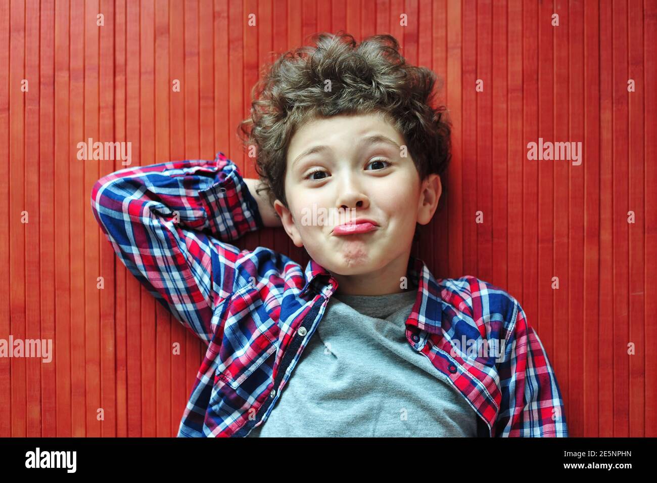 Funny little boy makes funny faces Stock Photo - Alamy