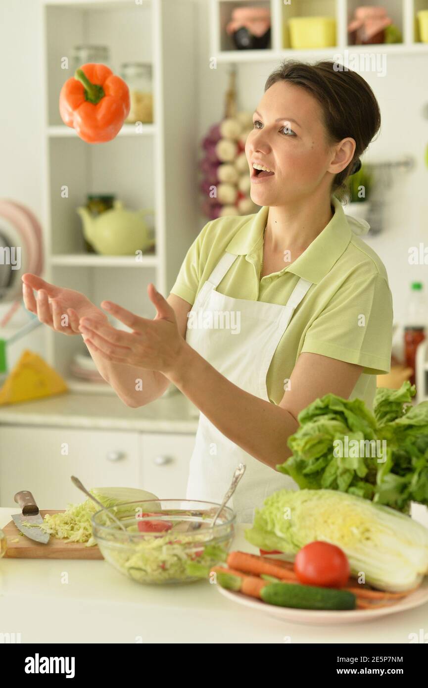 Portrait of beautiful young woman cooking in kitchen Stock Photo - Alamy
